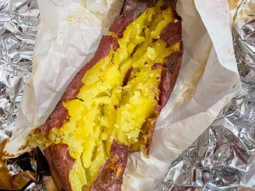 Sweet potato on the grill in foil store
